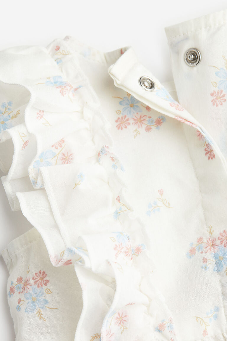 Flounce-trimmed romper suit