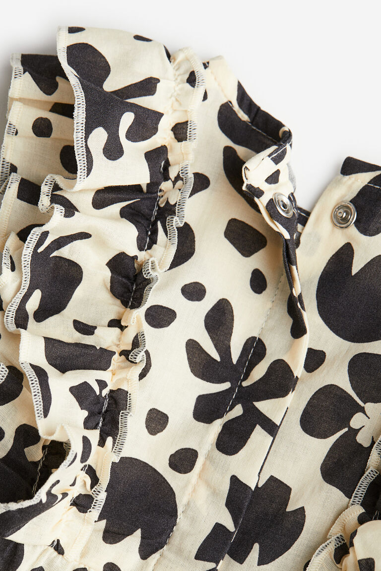 Flounce-trimmed romper suit